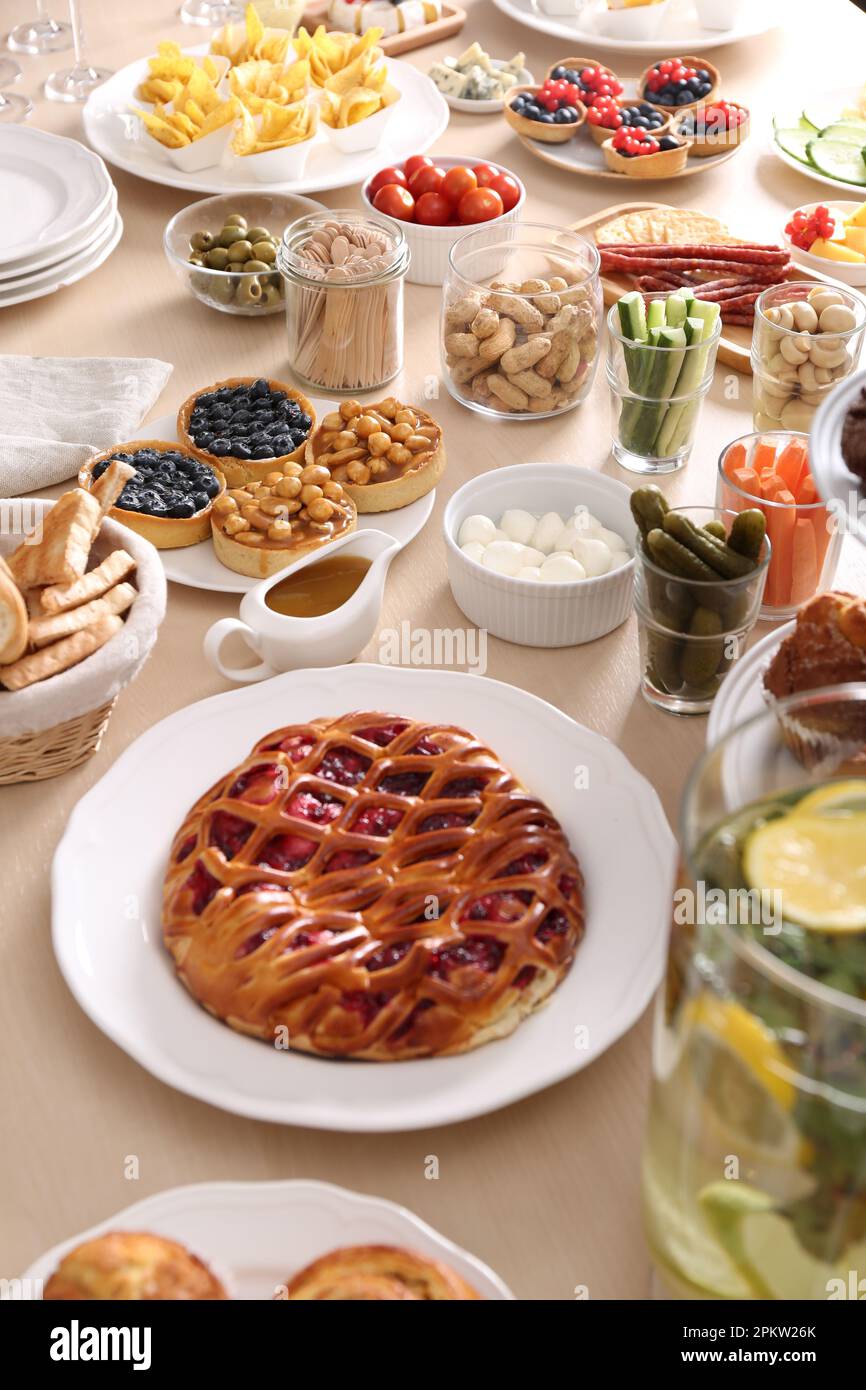 Variety of snacks on wooden table in buffet style Stock Photo - Alamy
