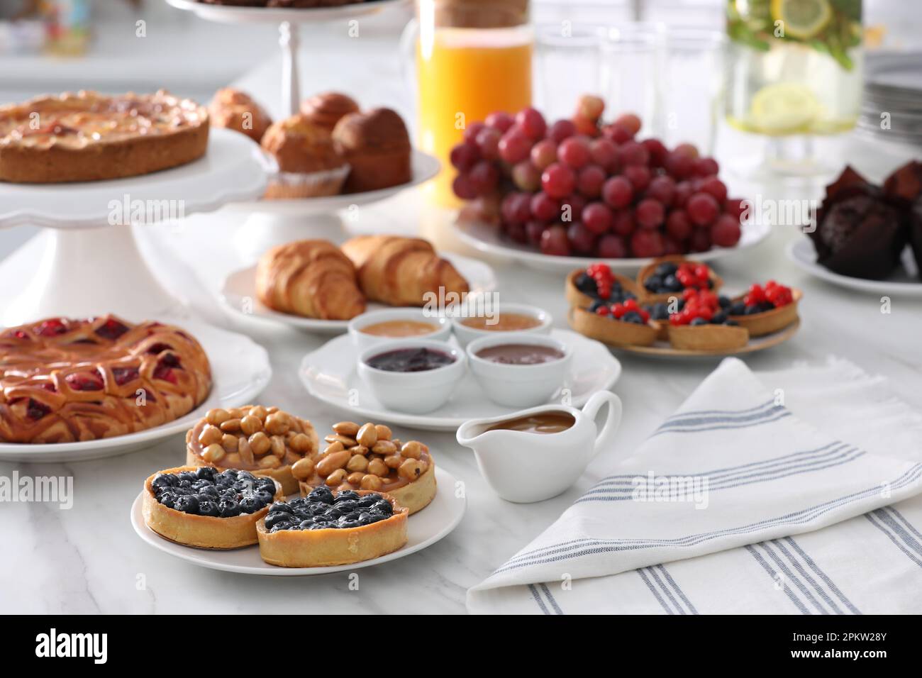 Variety of snacks on white marble table in buffet style Stock Photo - Alamy