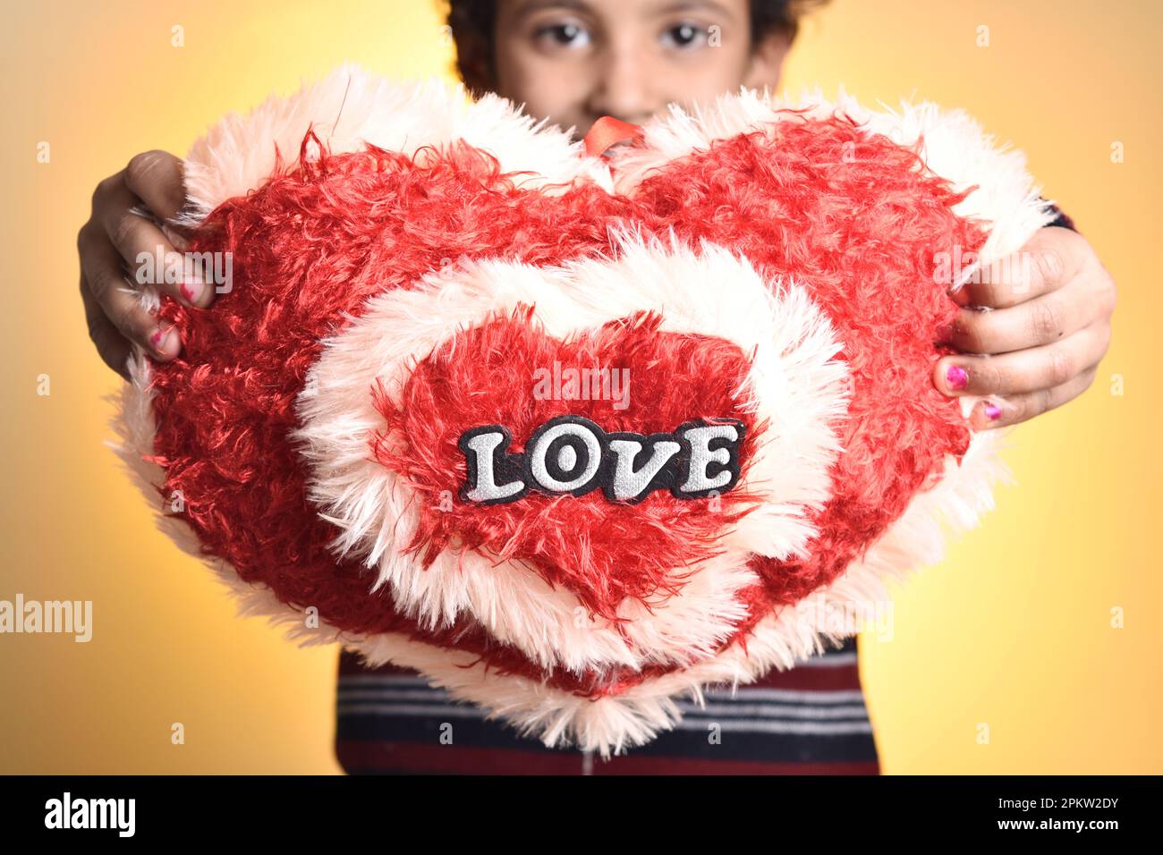 Heart shape soft toy on hand Stock Photo - Alamy