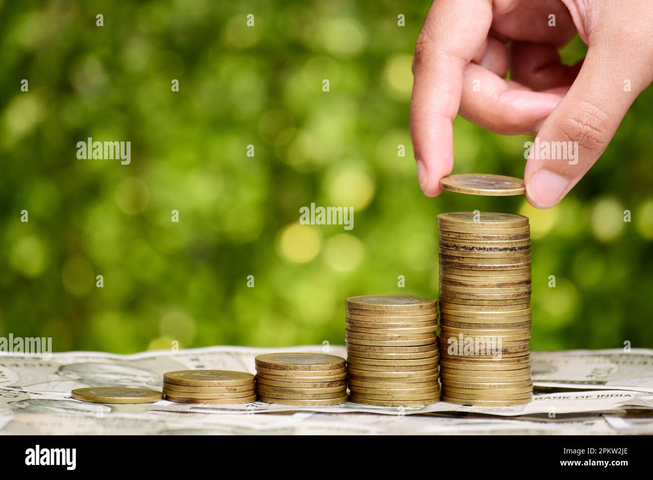hand and coin money investment concept Stock Photo - Alamy
