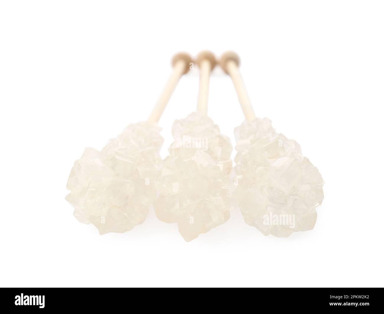 Wooden sticks with sugar crystals isolated on white. Tasty rock candies ...
