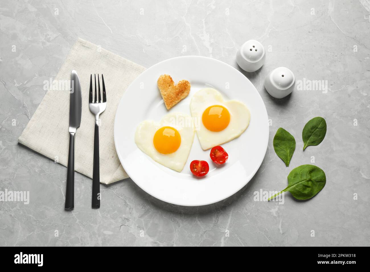 Heart shaped fried eggs with toast served on marble table, flat lay Stock Photo - Alamy