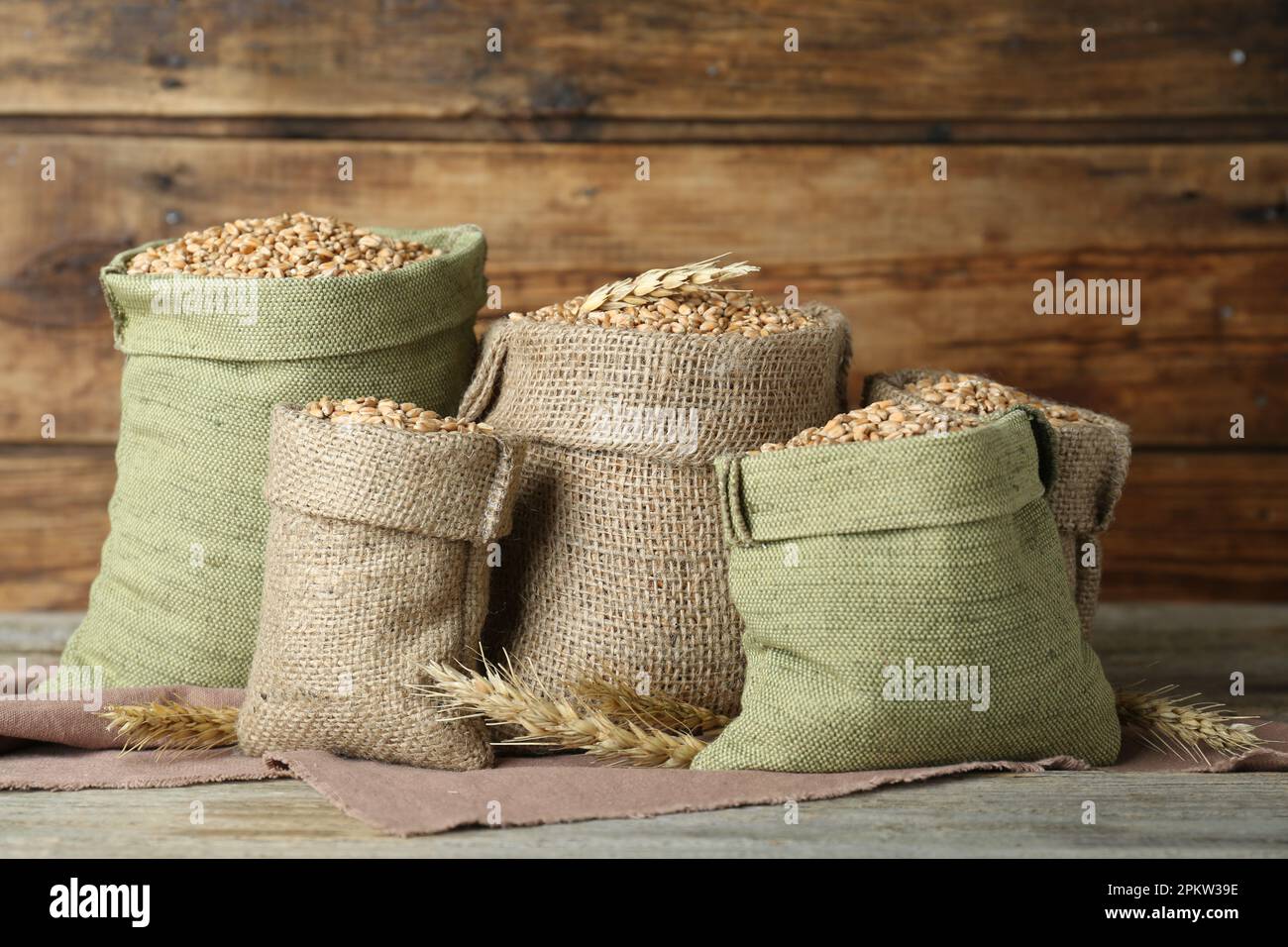 Many sacks with wheat grains wooden wall Stock Photo - Alamy