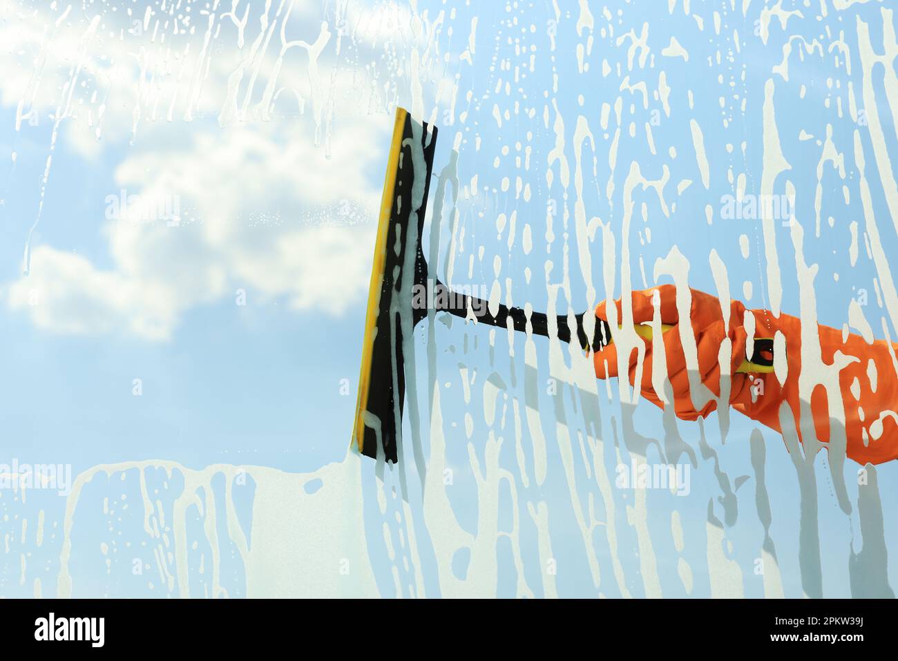 Person cleaning glass with squeegee , view from inside Stock Photo - Alamy