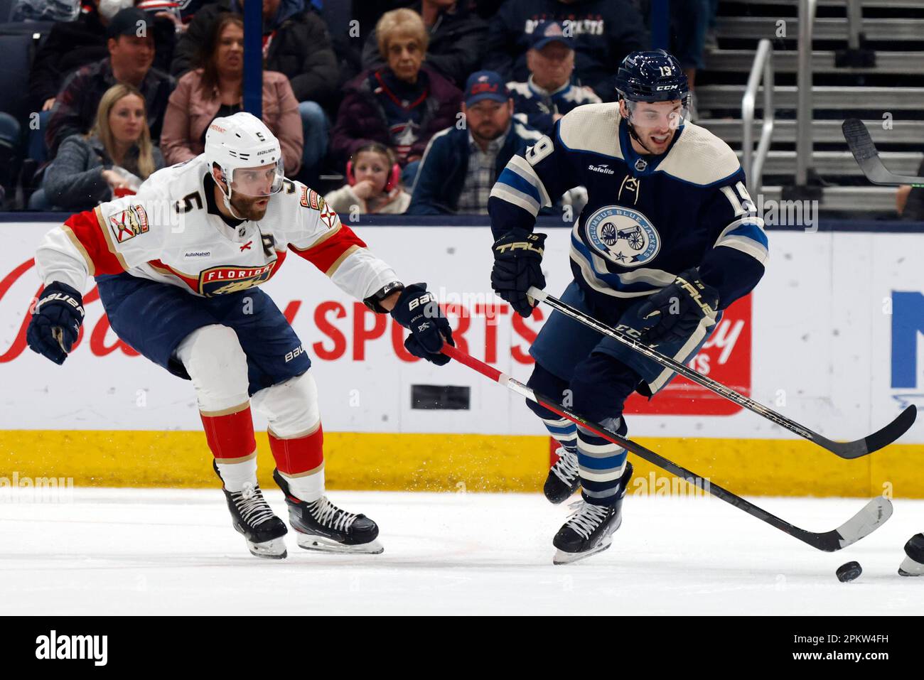 Columbus Blue Jackets forward Liam Foudy, right, chases the puck in ...