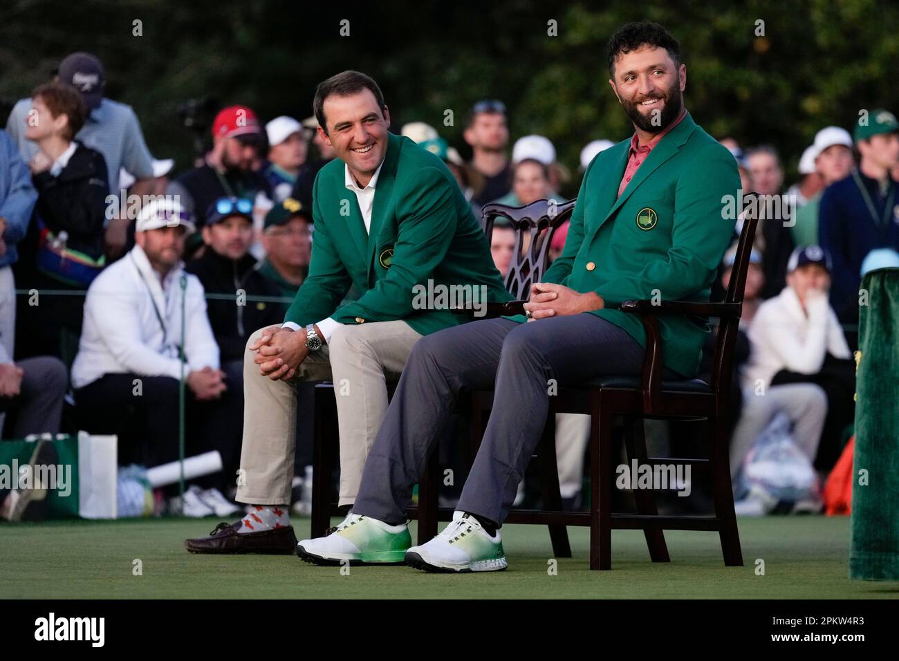 Scottie Scheffler sits with Jon Rahm, of Spain, after Rahm won the ...