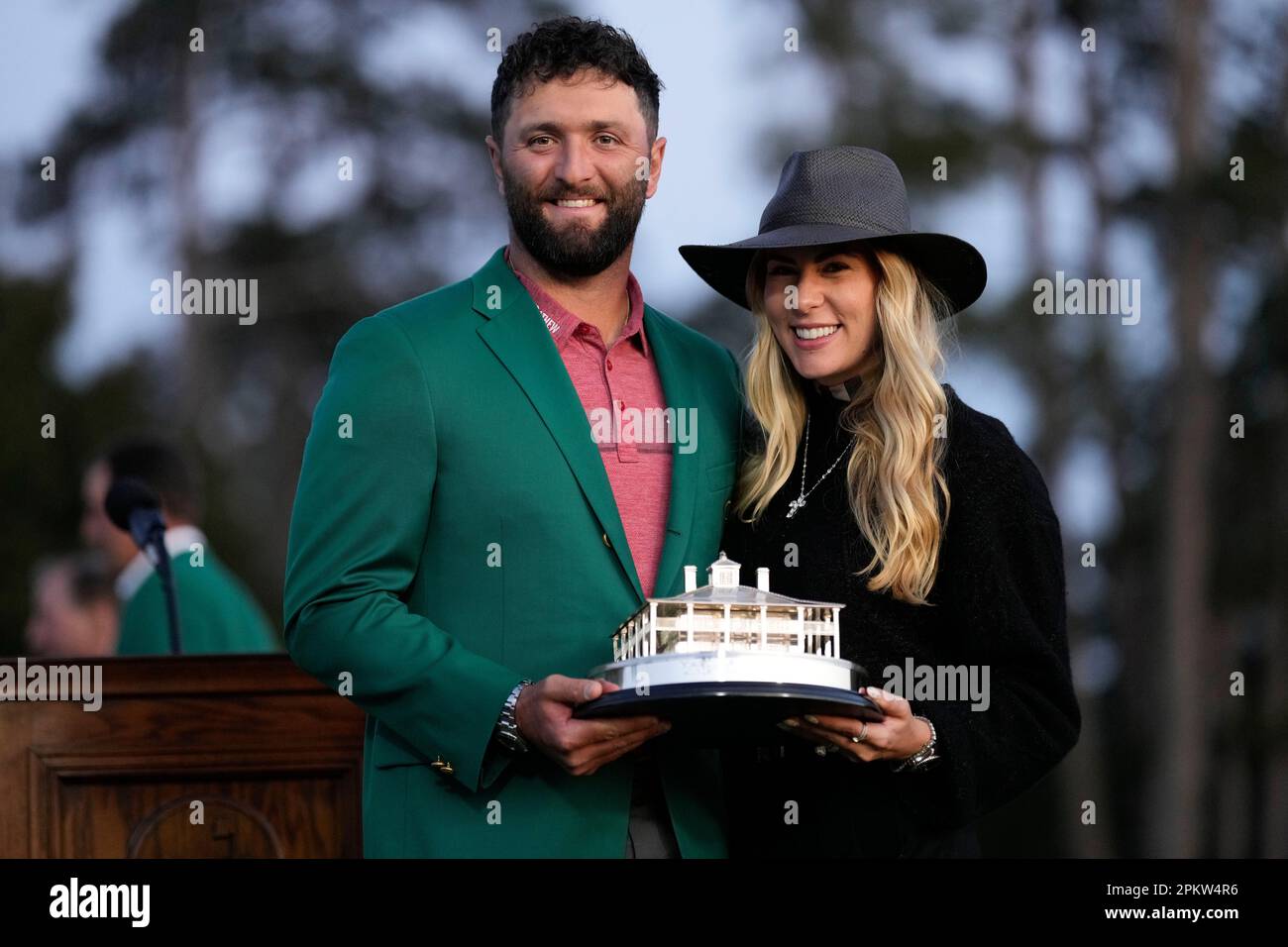Jon Rahm, of Spain, holds the trophy with his wife Kelley Cahill after ...