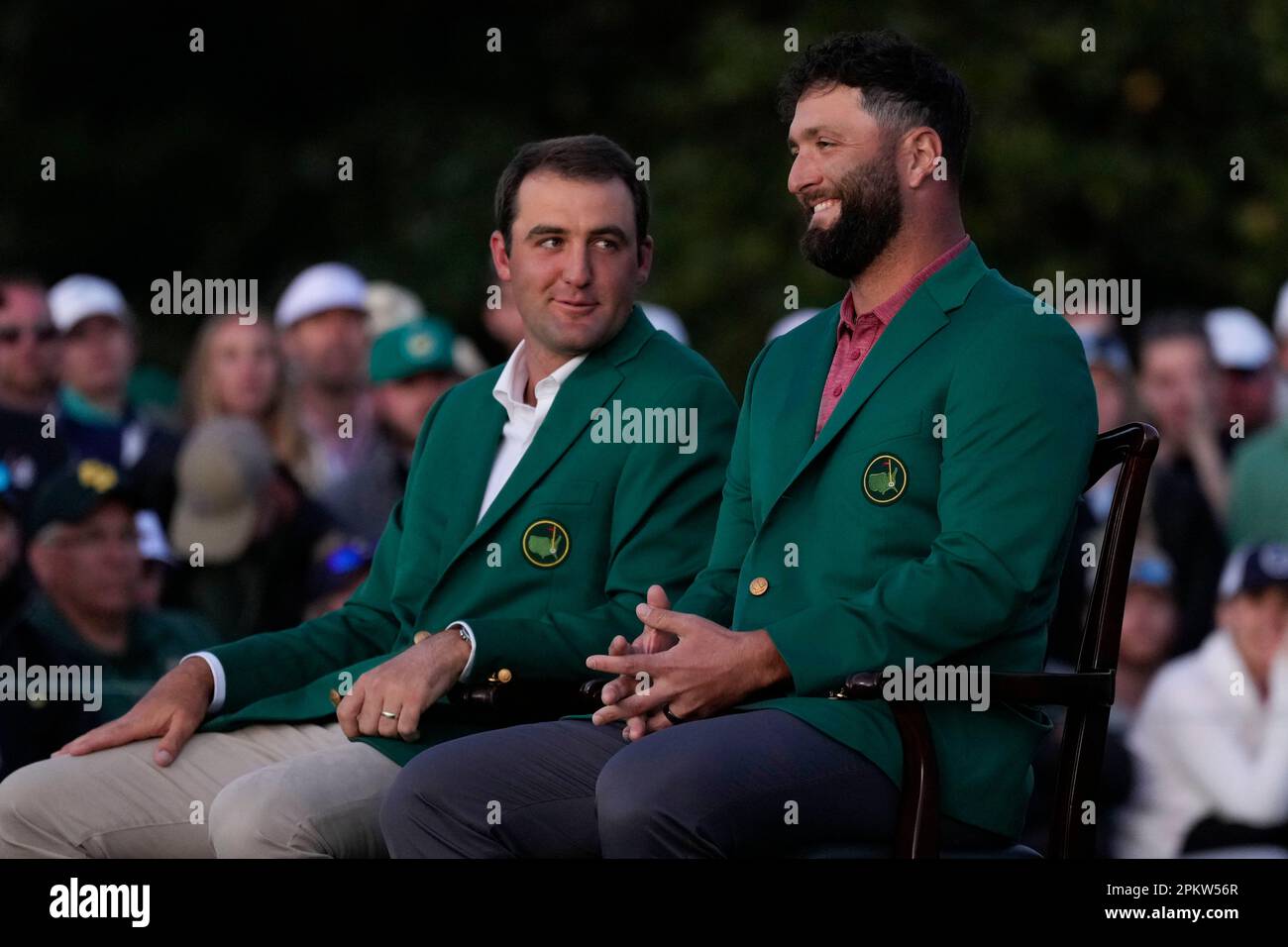 Scottie Scheffler sits with Jon Rahm, of Spain, after Rahm won the ...