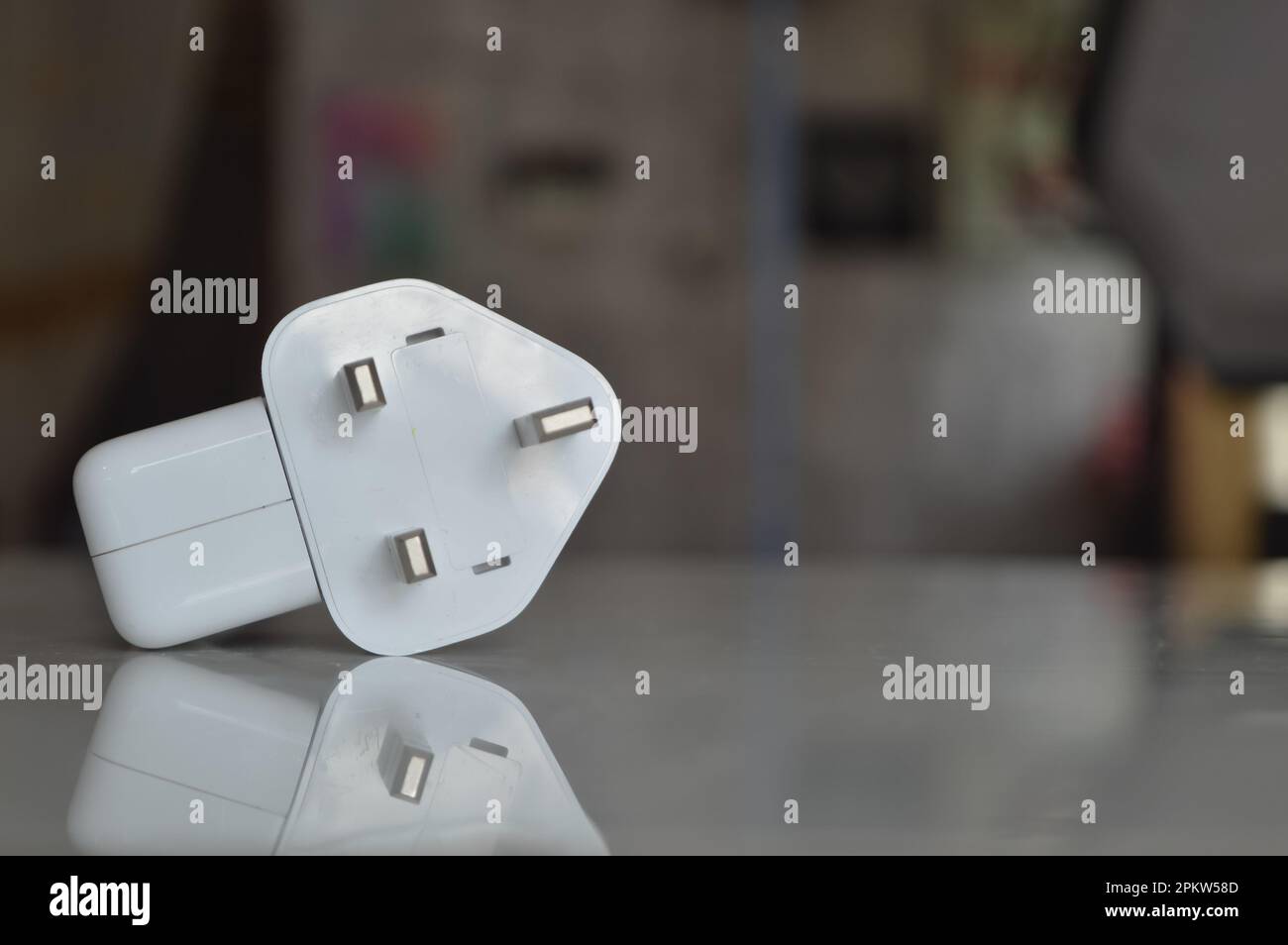 Front view of white plug with blurred background Stock Photo - Alamy