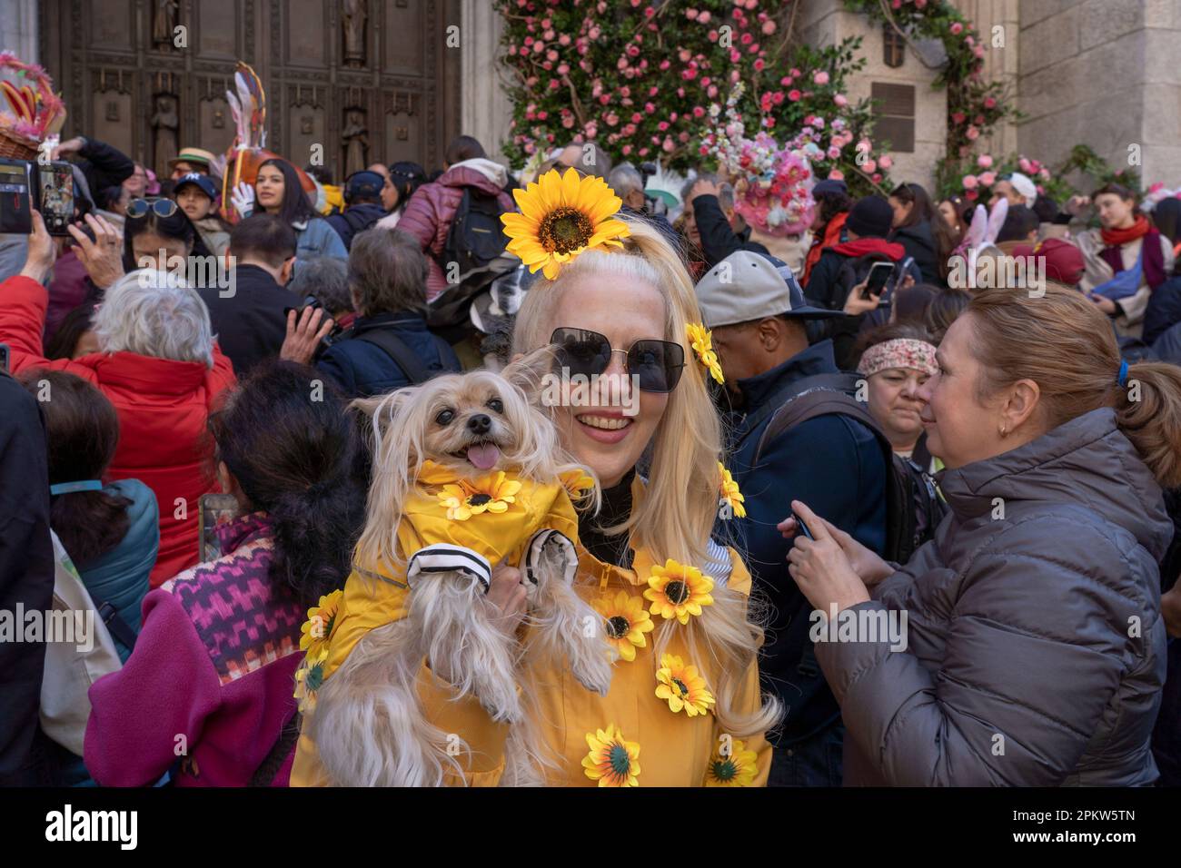NEW YORK, NEW YORK - APRIL 09: A woman holds a dog during the Easter Parade and Bonnet Festival ...