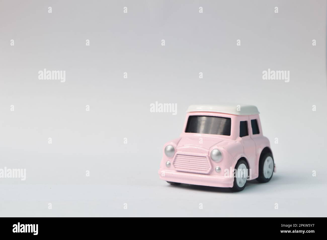 Pink toy car isolated on a white background Stock Photo - Alamy