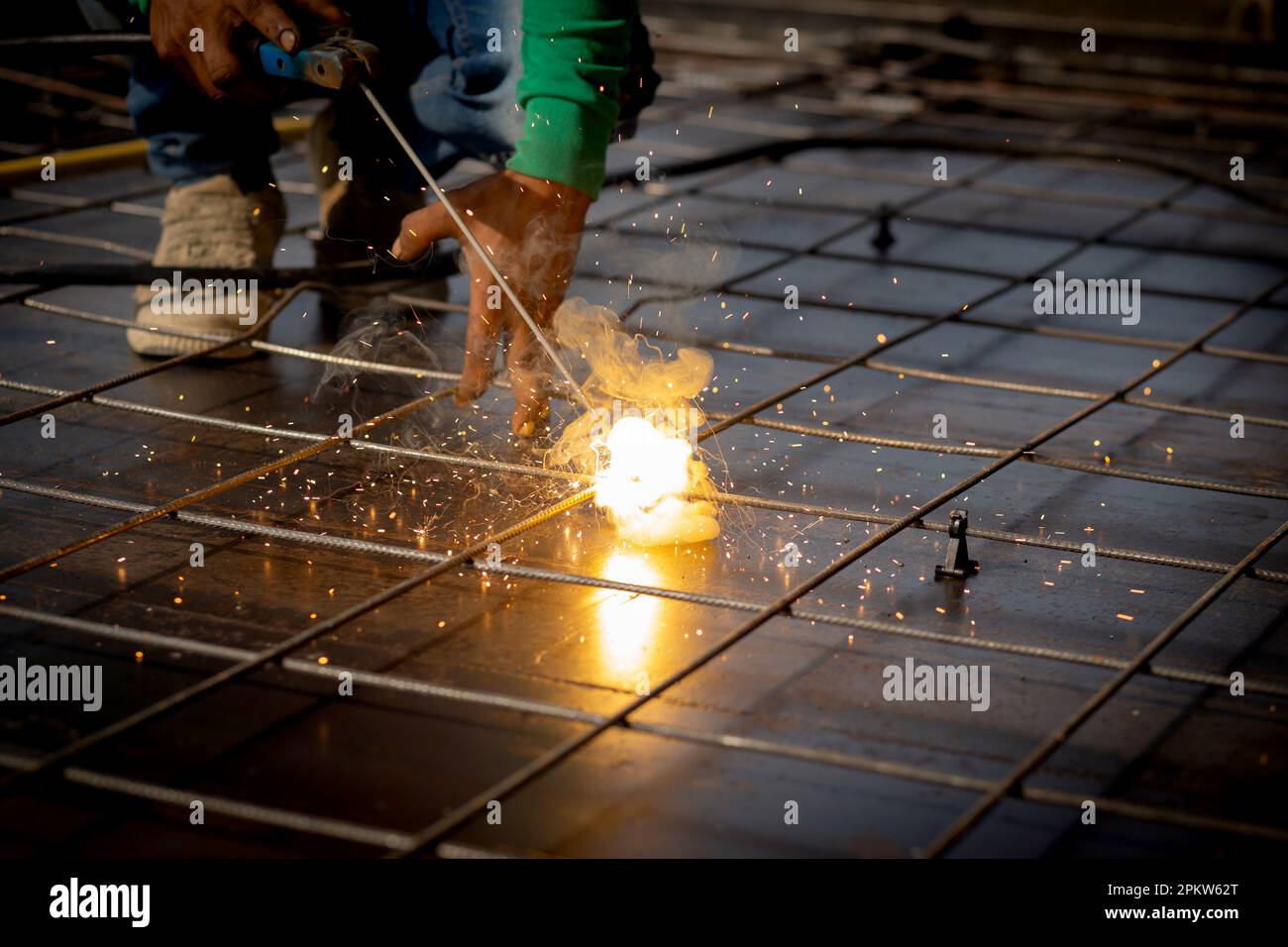 Closeup hands young worker using machine welding iron with hands ...