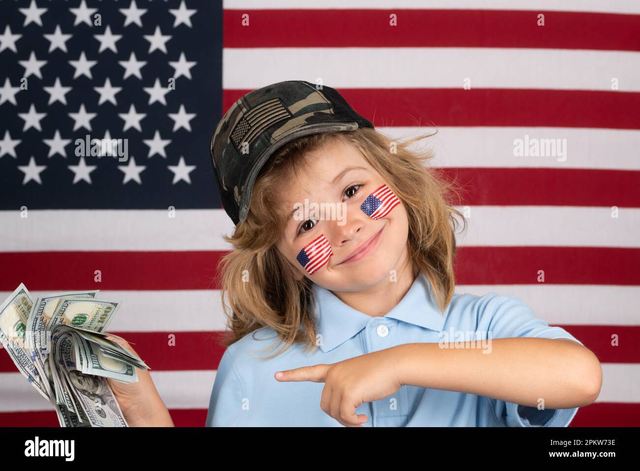 American money. Kid having a lot of hundred dollars isolated on studio ...