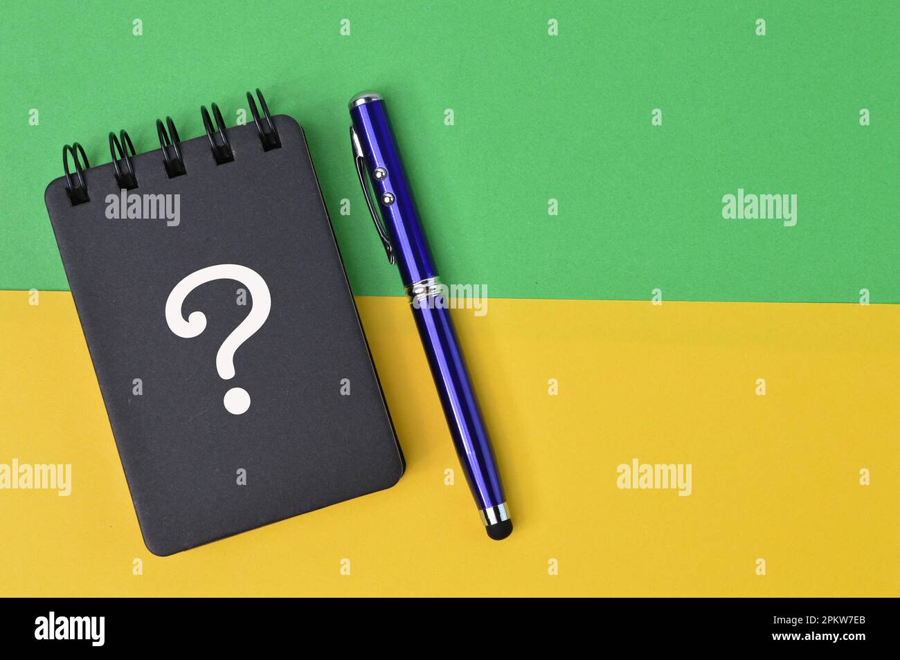 Question mark drawn on notebook over green and yellow background Stock ...