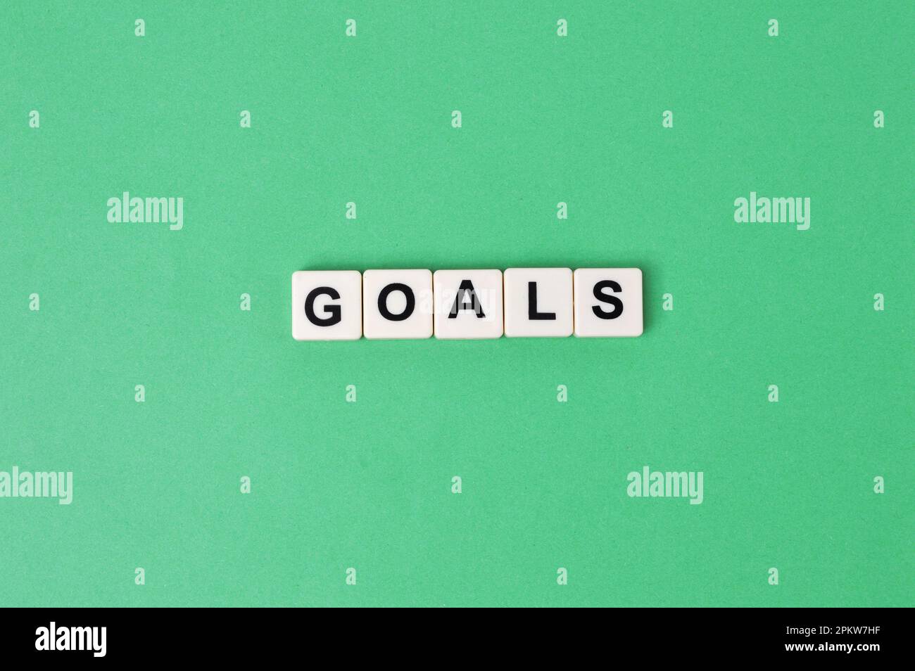 Square letters with text GOALS over green background Stock Photo - Alamy