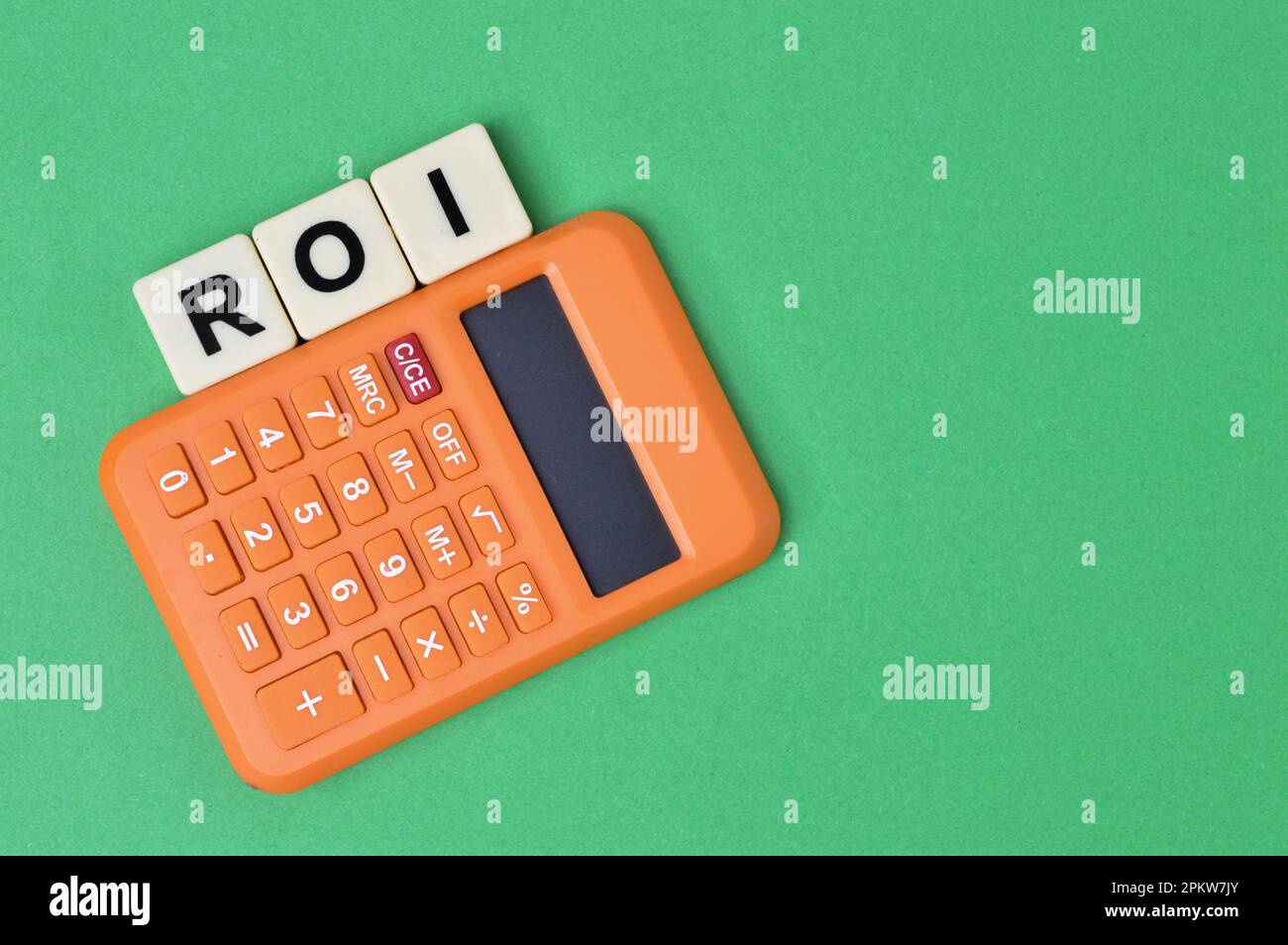 Calculator and square letters with text ROI stands for Return On ...