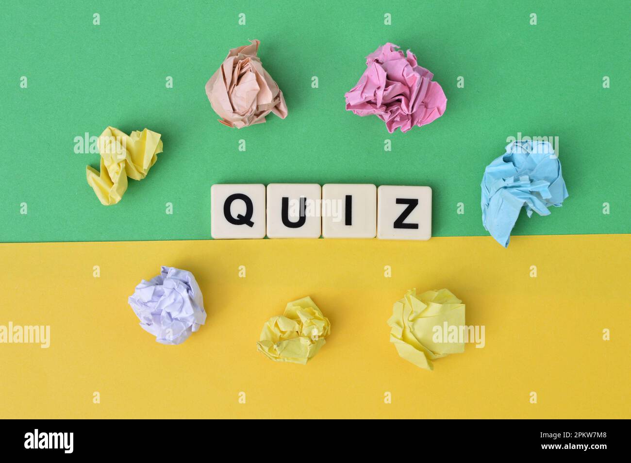Waste papers and square letters with text QUIZ Stock Photo - Alamy