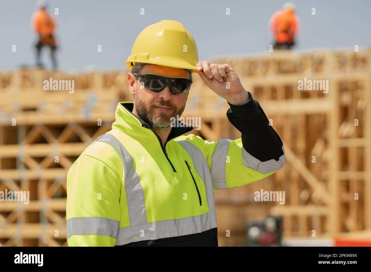 Construction worker at house under construction. Builder in building ...