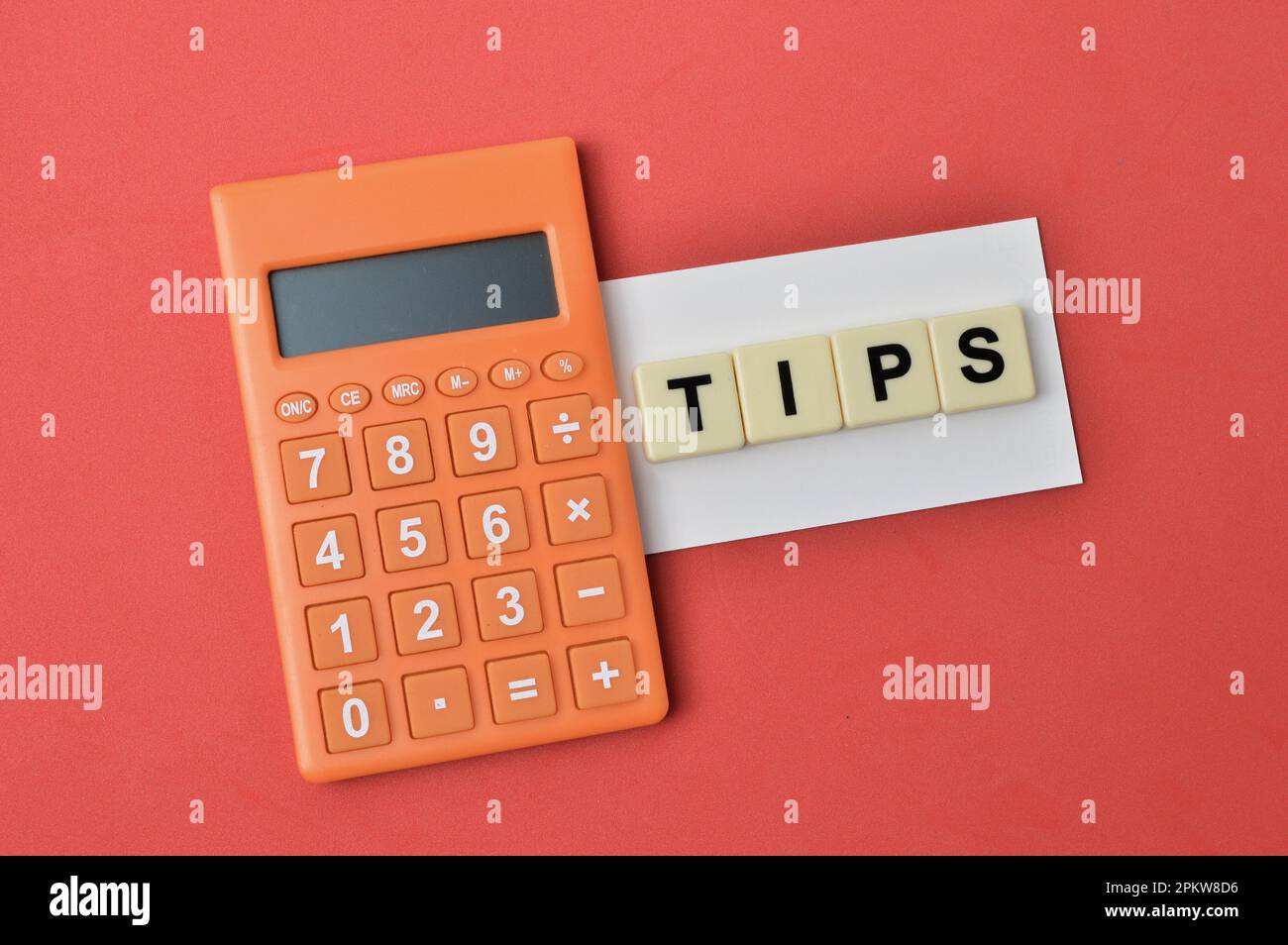 Calculator and square letters with text TIPS over red background Stock ...