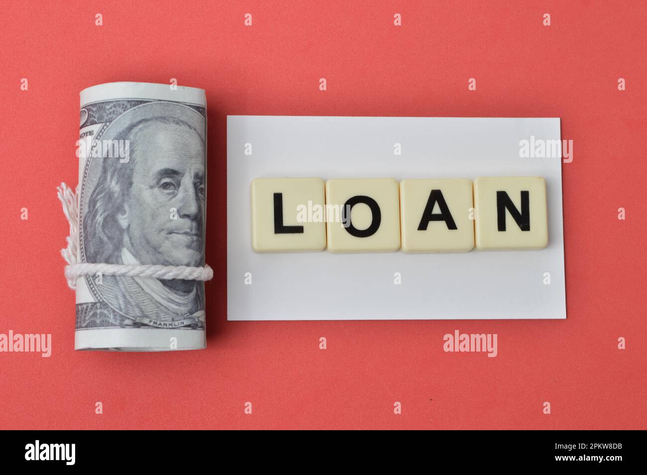 Money banknote and square letters with text LOAN over red background ...