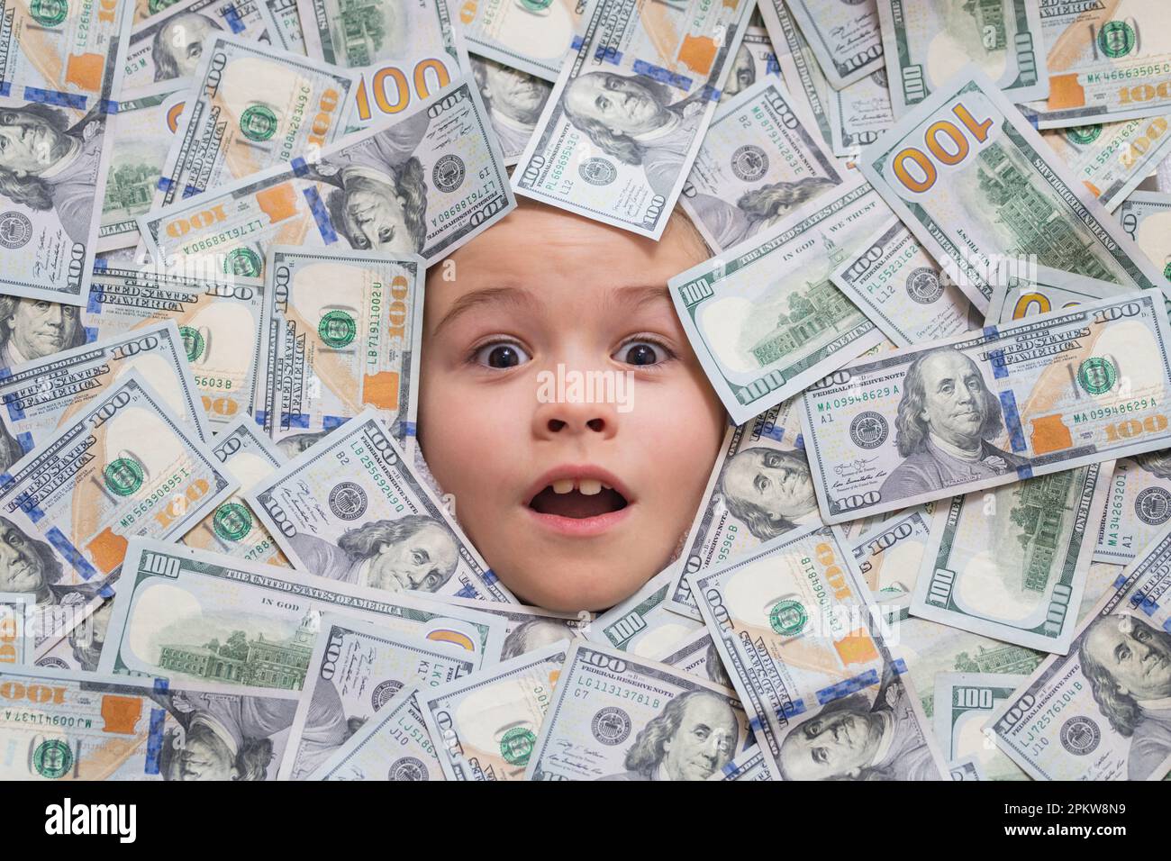 Money win, big luck. Funny child face in money dollars banknotes ...