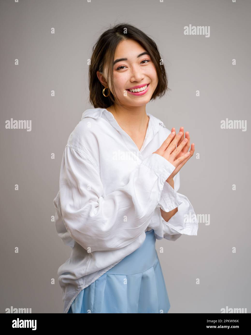 12 Half Body Portrait Of Young Asian Woman In A Short Blue Skirt And White Long Sleeve Blouse