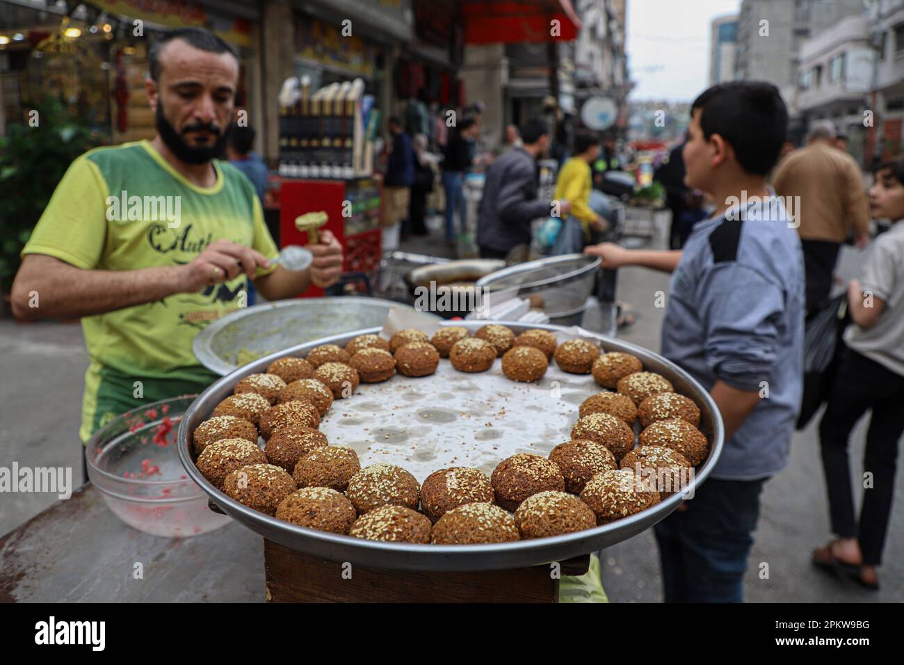 Gaza. 9th Apr, 2023. Vendors prepare falafel, a traditional sweet ...