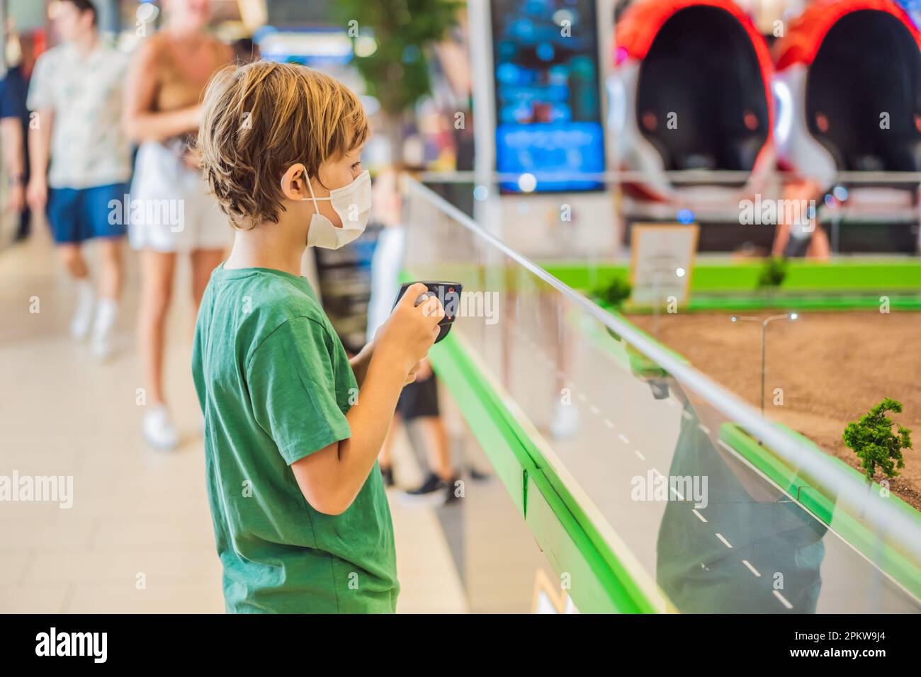Adorable cute little child playing with toy on remote control, in the ...