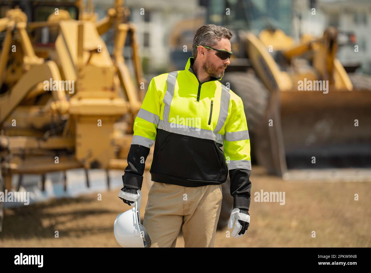 Worker with bulldozer on site construction. Man excavator worker ...