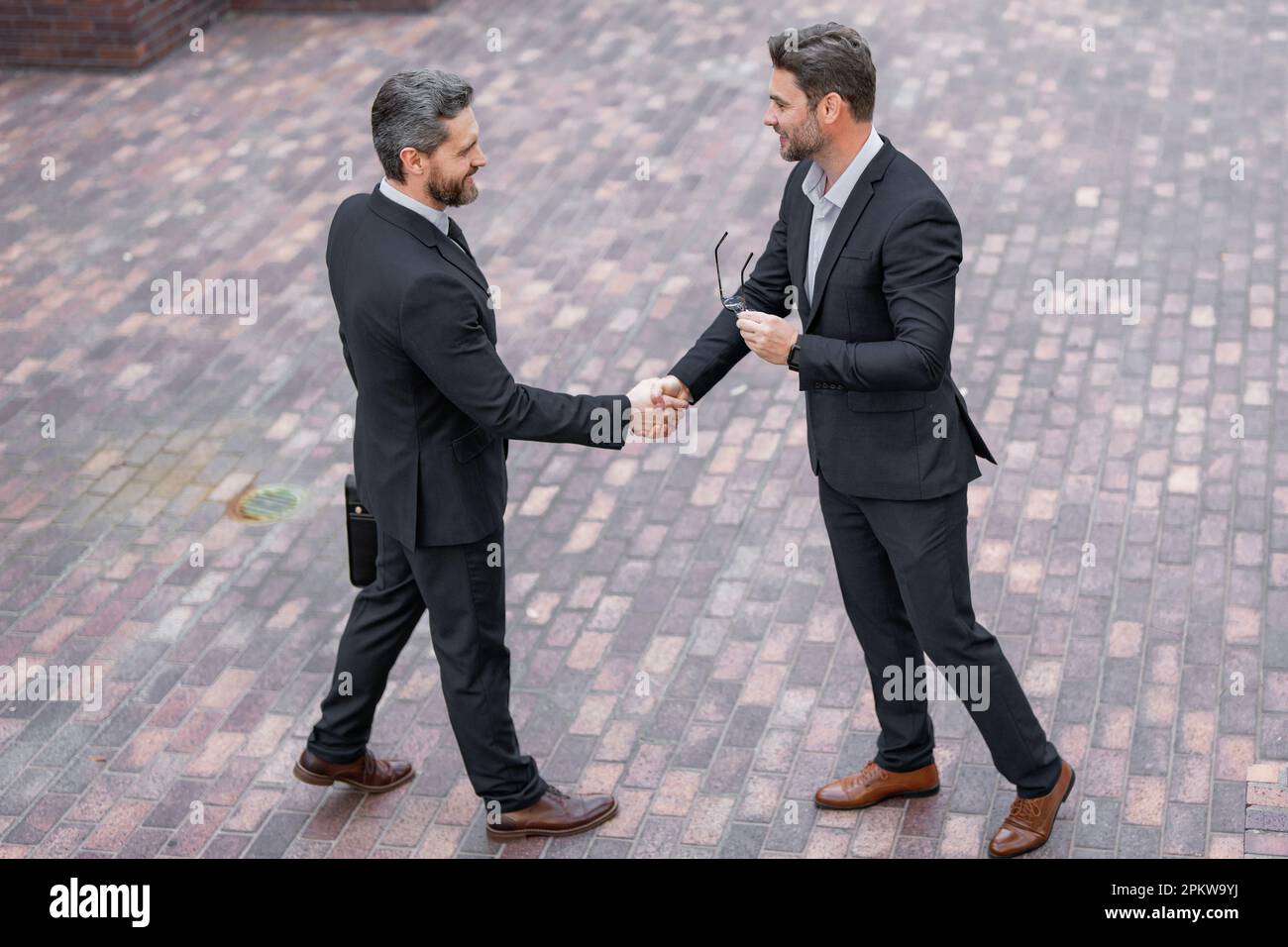 Business men have a meeting outside. Business man shaking hands. Two ...