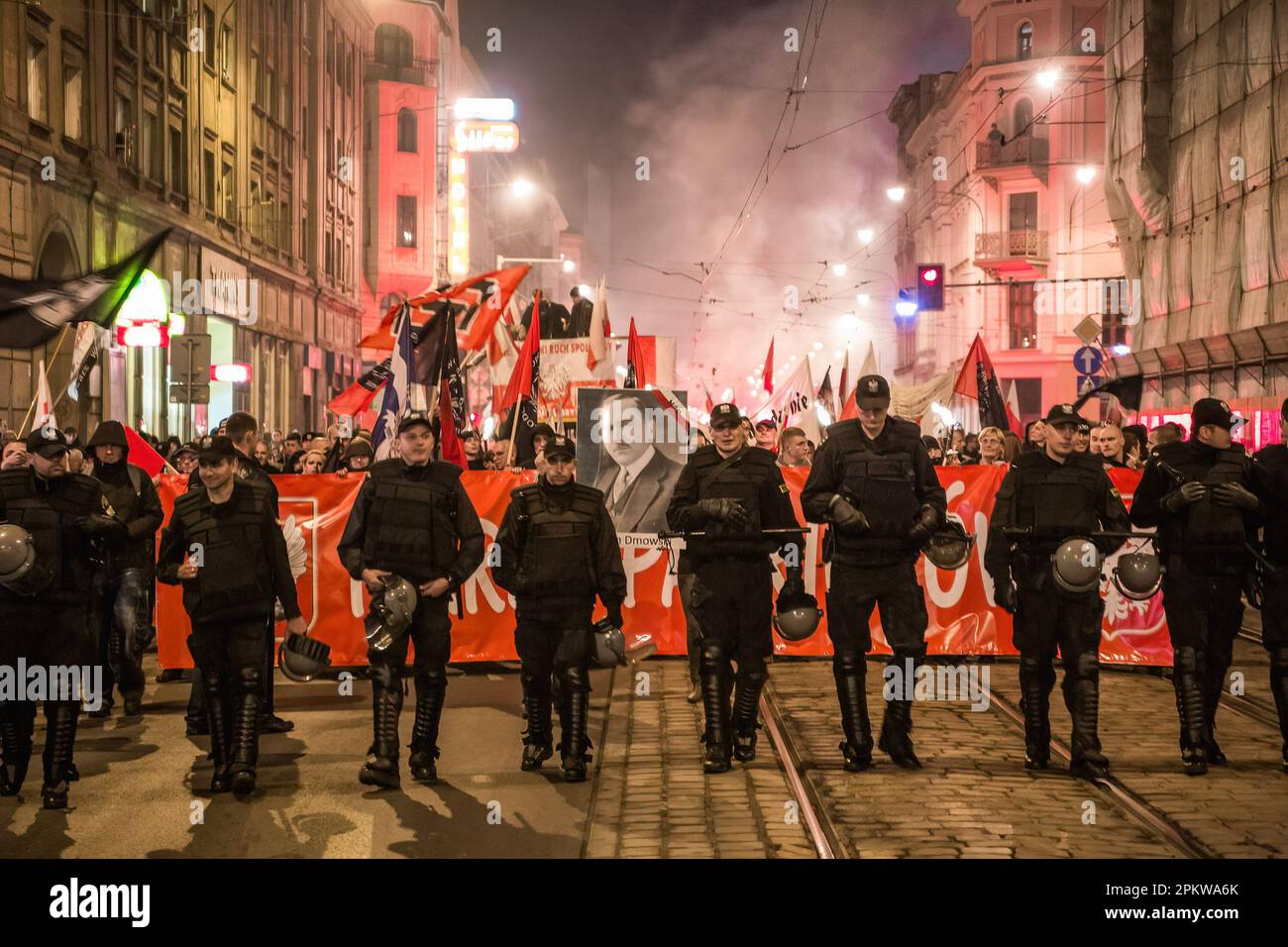 Policemen walk ahead of the marchers during the protest. On the front ...
