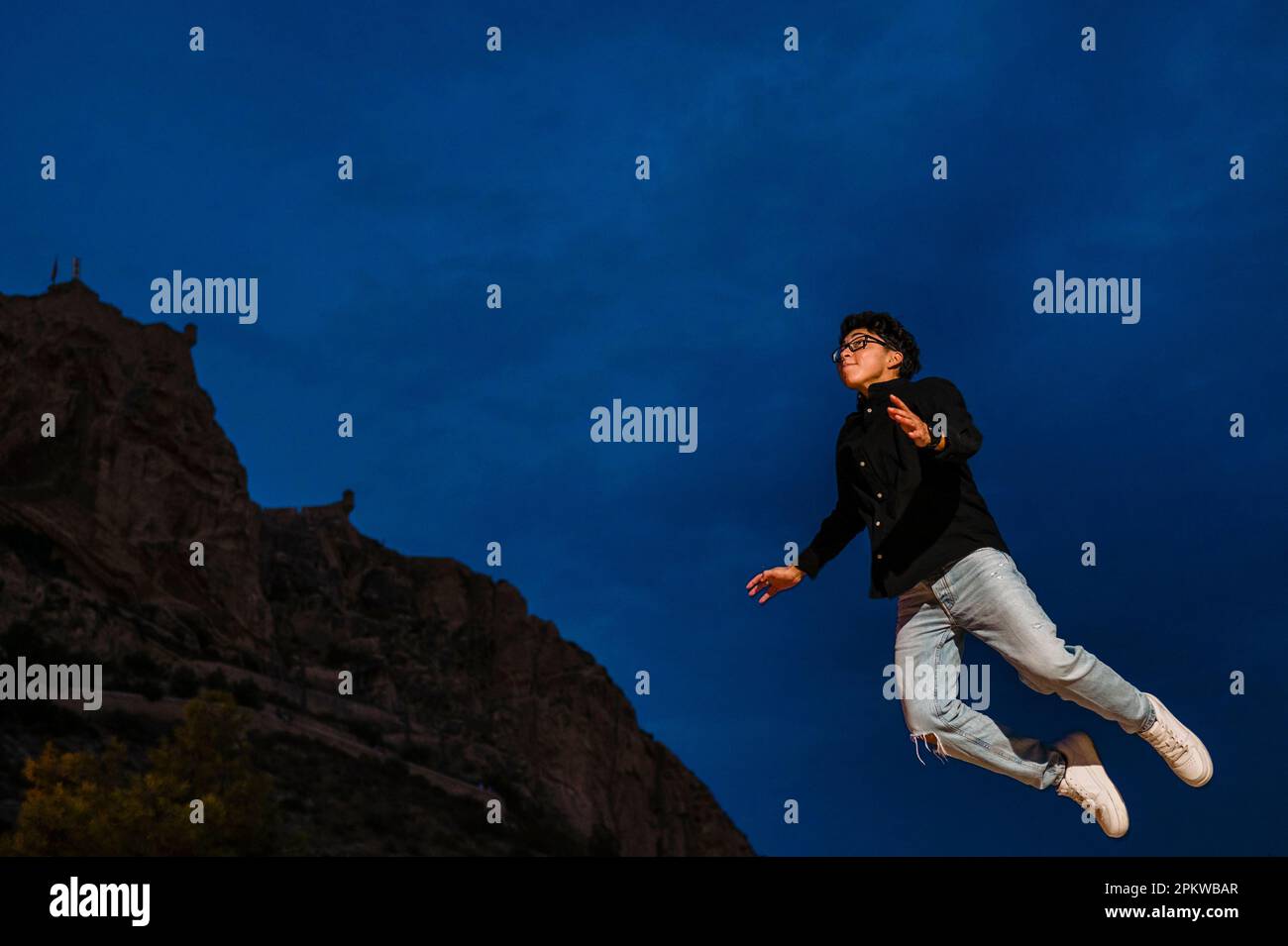 Young transgender man jumping outdoors at night Stock Photo - Alamy