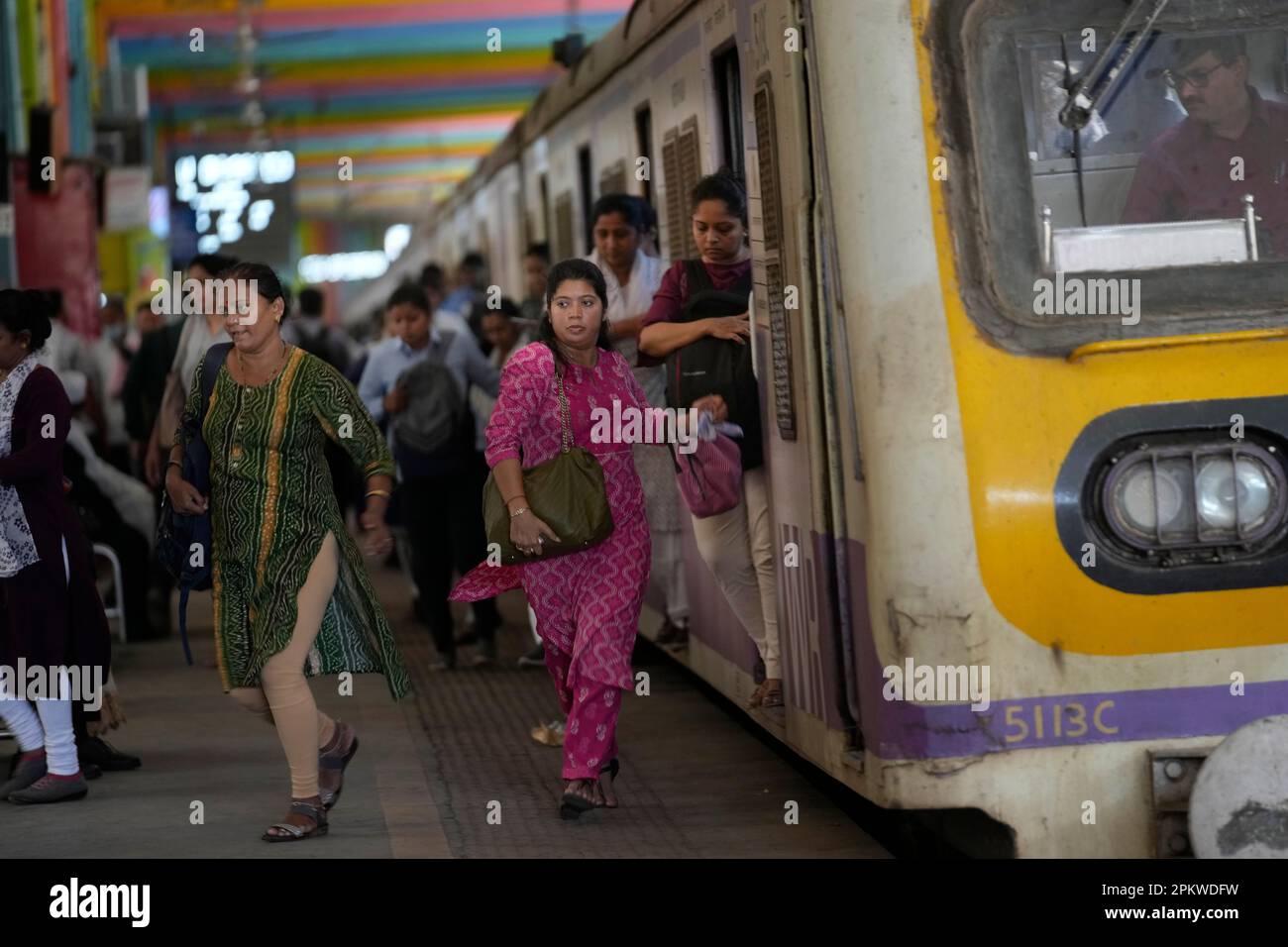 Women rush out of a train during peak hours at Churchgate station in ...