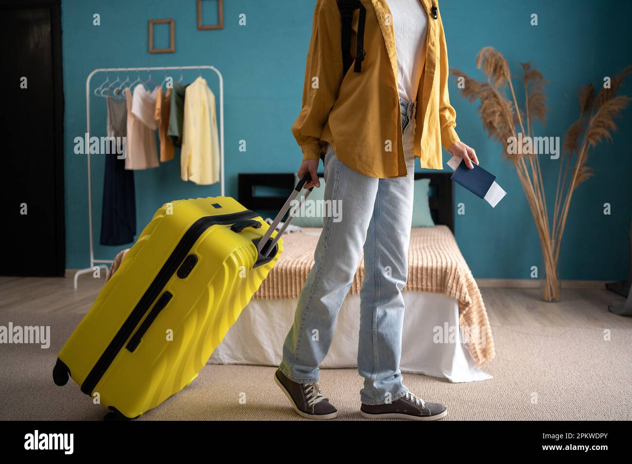 Close up of tourist woman pulling her luggage in hotel bedroom after check-in. Enjoy holiday and ...