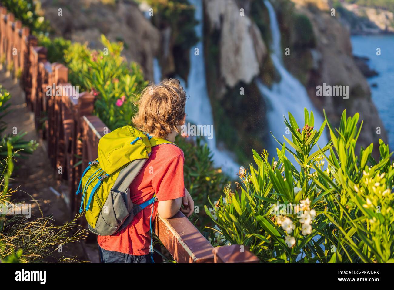 Boy tourist with a backpack on the background of Duden waterfall in ...