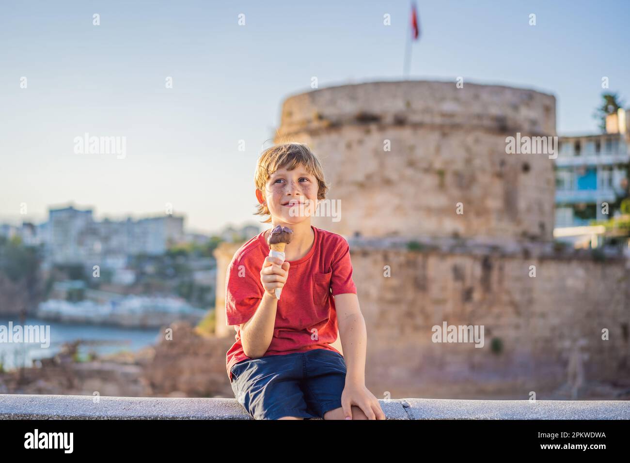 Boy tourist eating turkish ice cream on background of Hidirlik Tower in ...