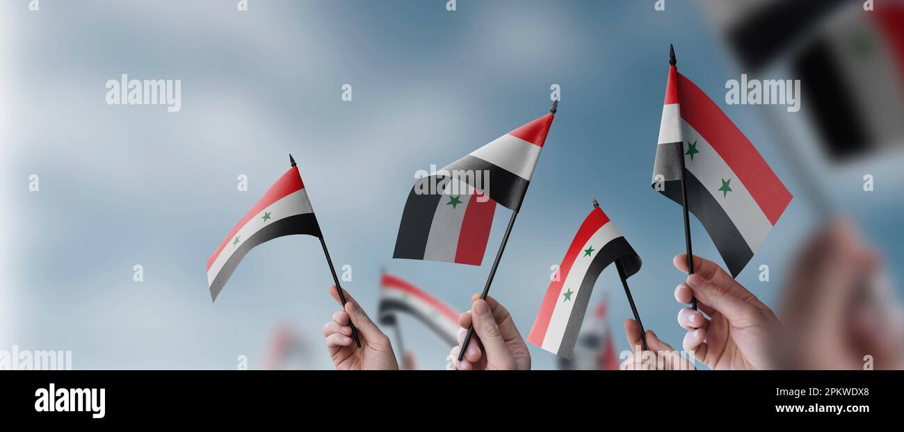 A group of people holding small flags of the Syria in their hands Stock ...