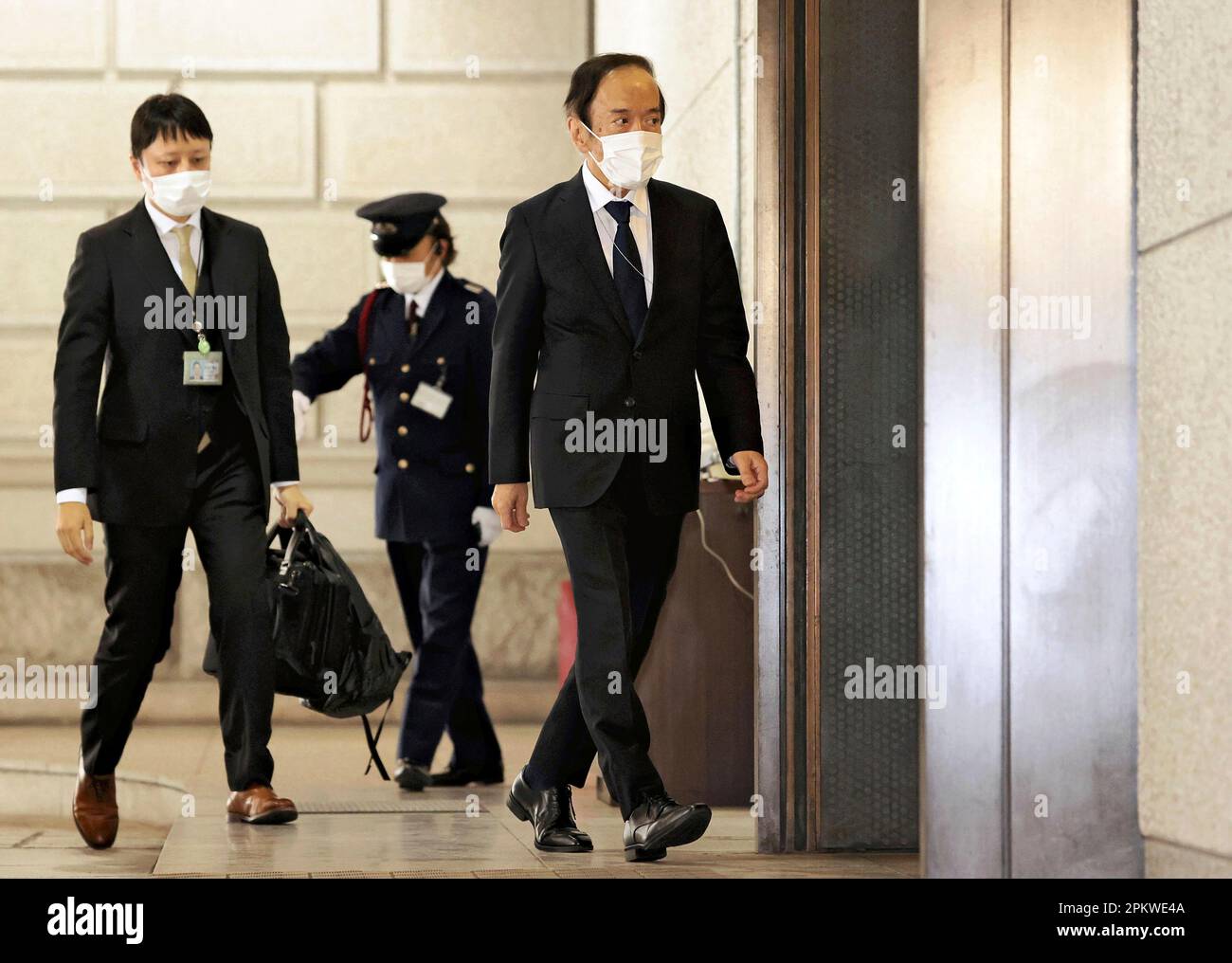 Kazuo Ueda (R), a new governor of the Bank of Japan (BO) arrives at its ...