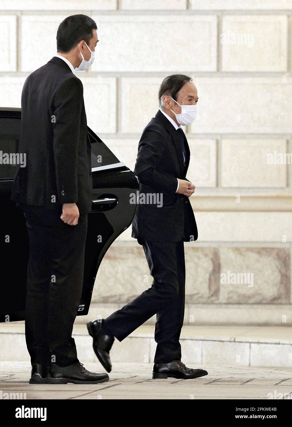 Kazuo Ueda (R), a new governor of the Bank of Japan (BO) arrives at its ...