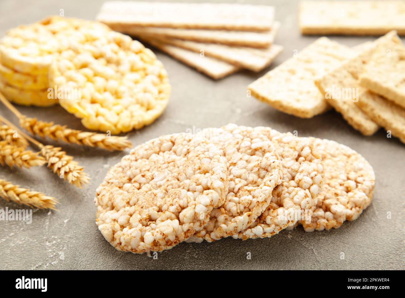 Different types of crispbread on grey background. Top view Stock Photo ...