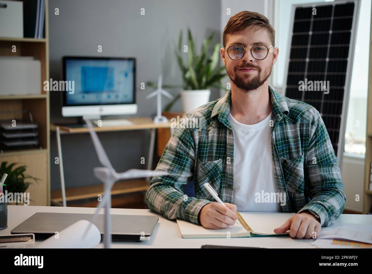 Portrait of engineer creating green energy project for client Stock ...