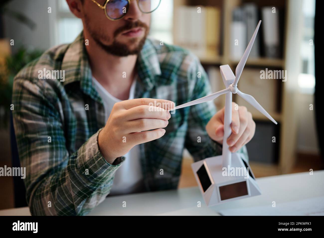 Engineer holding model of plastic wind turbine Stock Photo - Alamy