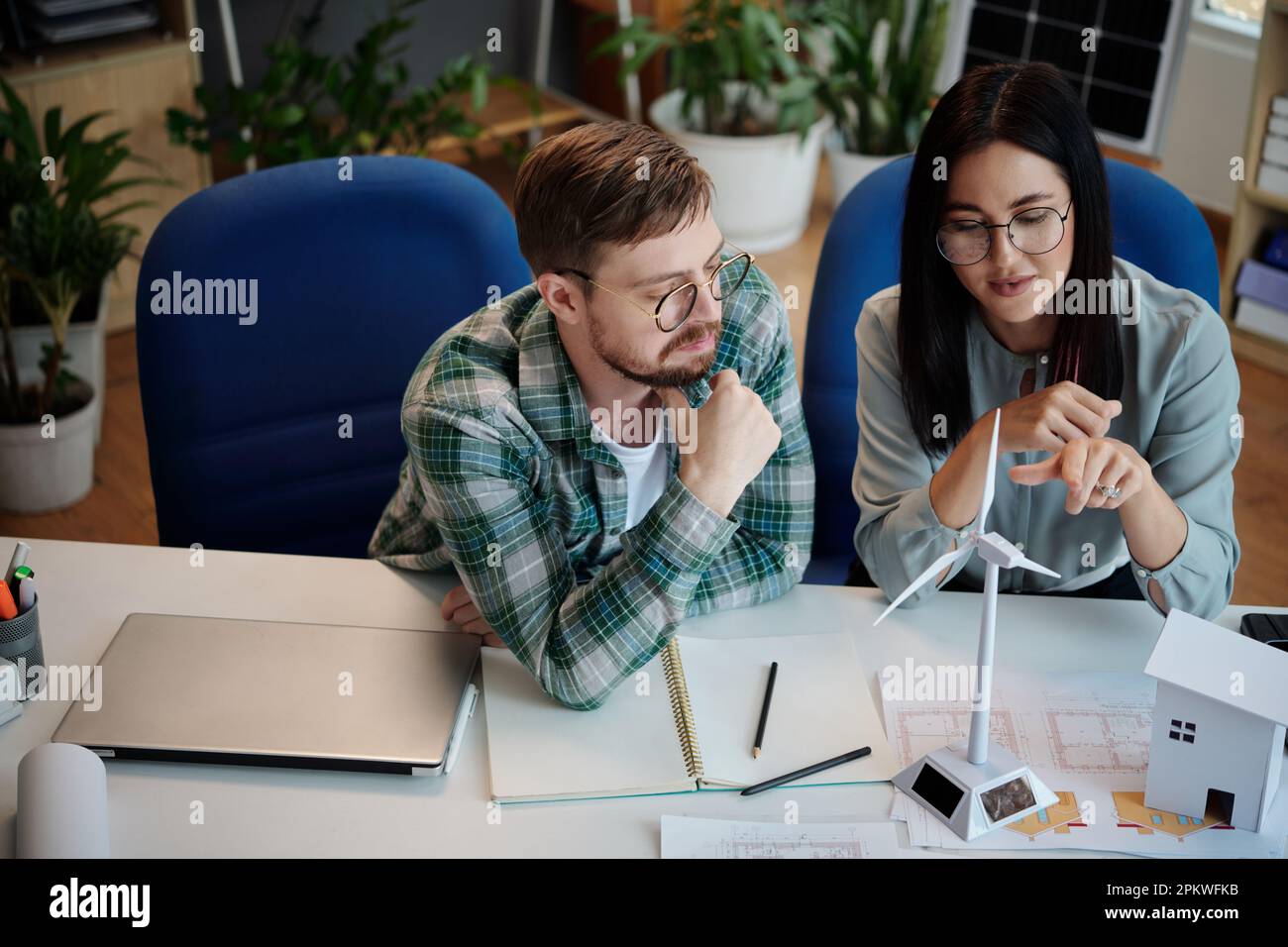 Engineers discussing plastic model of wind turbine for client Stock ...