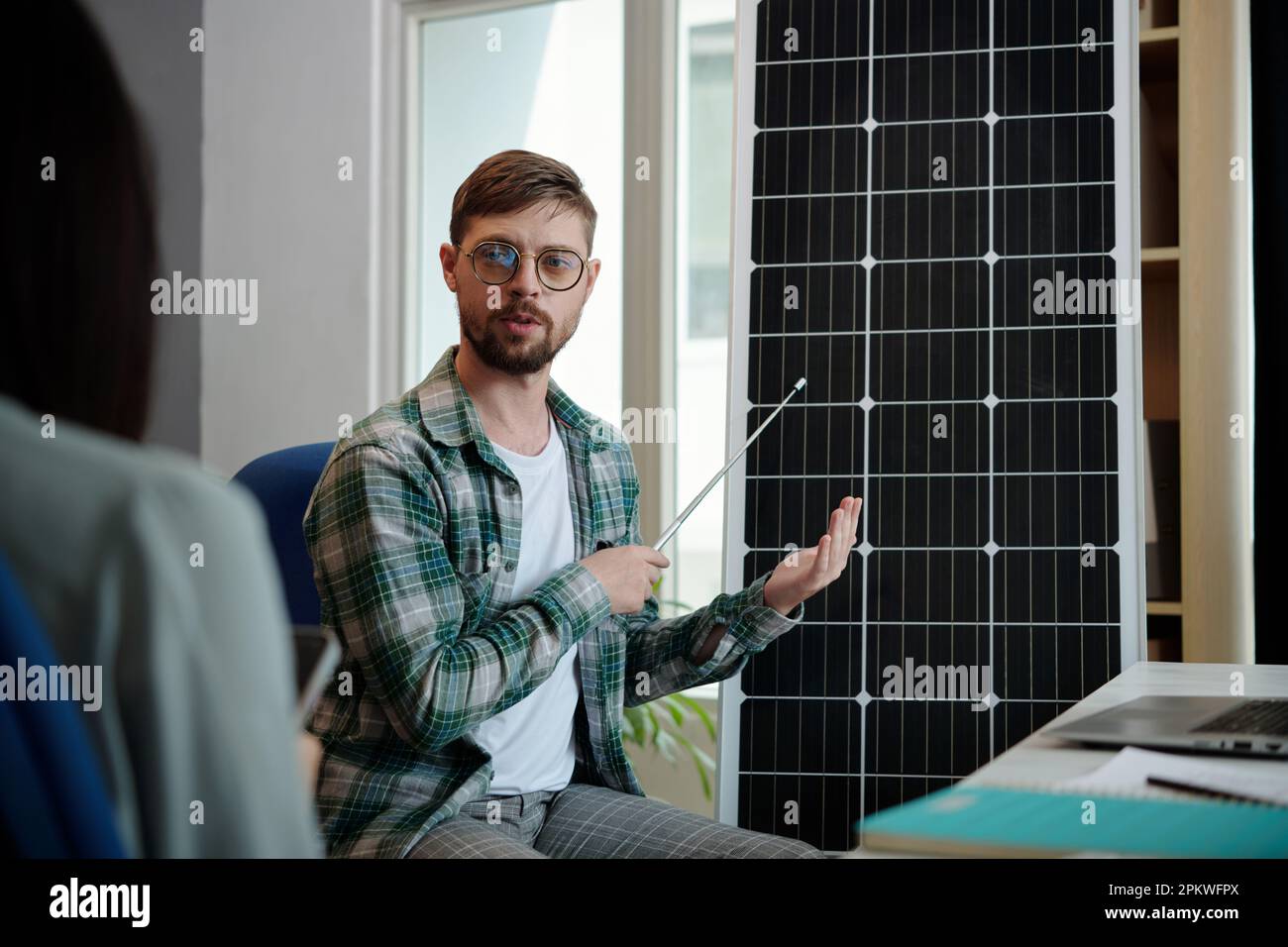 Solar energy sales manager explaining advantages of new model to ...