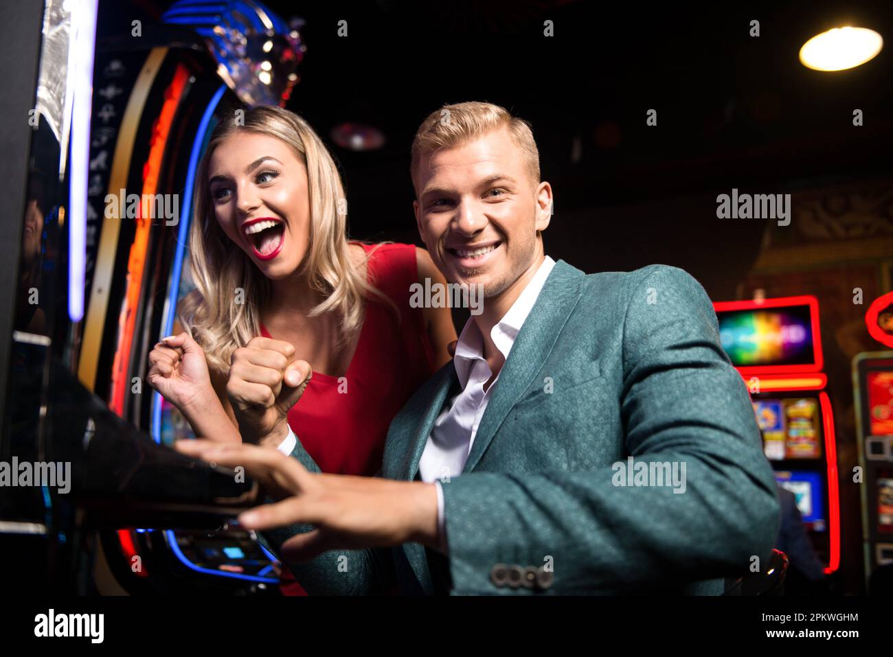 Beautiful and Well Dressed Friends Playing Automat Machine in the ...