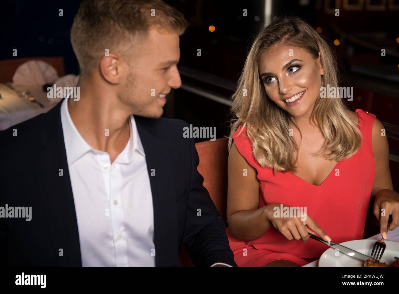 Romantic Couple Friends Eating At A Restaurant Table With Glass And ...