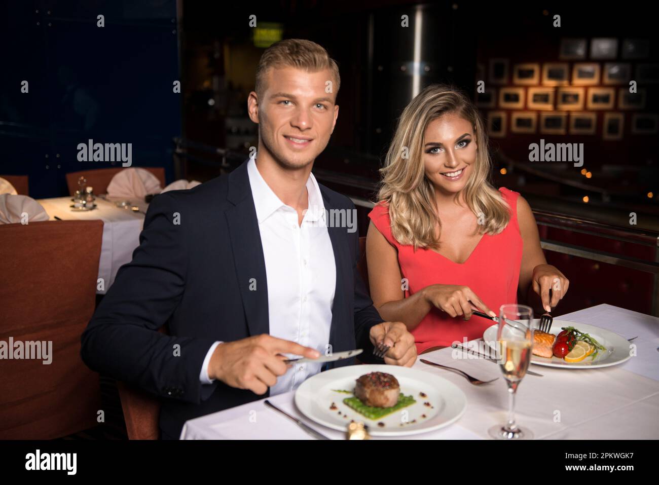 Romantic Couple Friends Eating At A Restaurant Table With Glass And ...