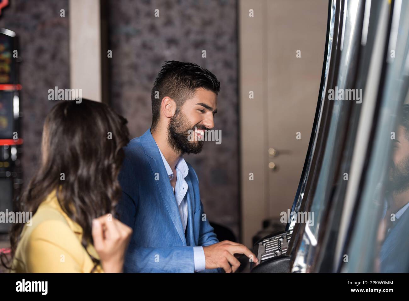 Young Group of People at the Automat Machine in a Casino and Celebrate ...