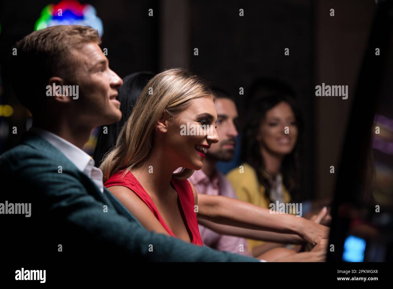 Beautiful and Well Dressed Friends Playing Automat Machine in the ...
