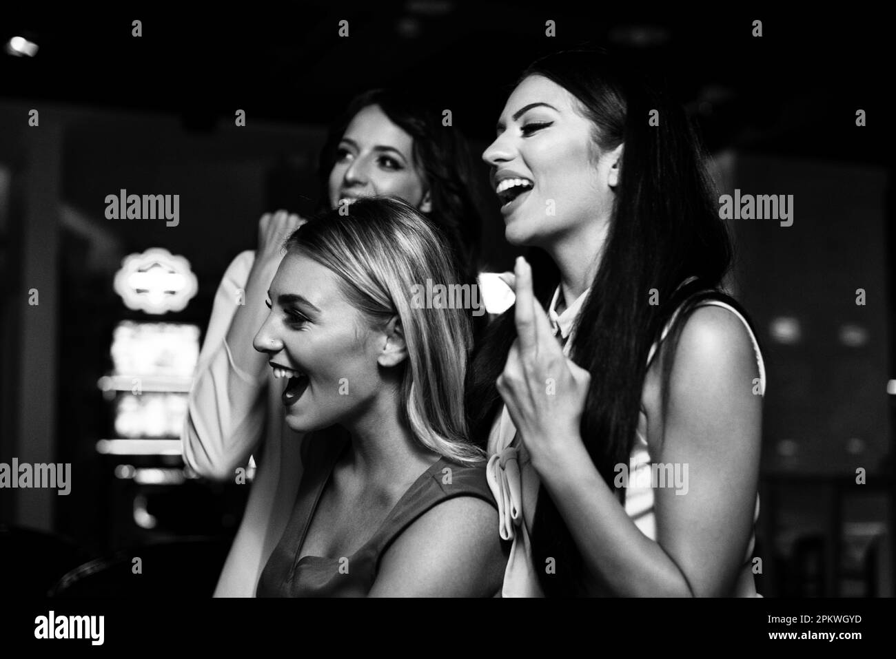 Beautiful and Well Dressed Girls Playing Automat Machine in the Casino ...